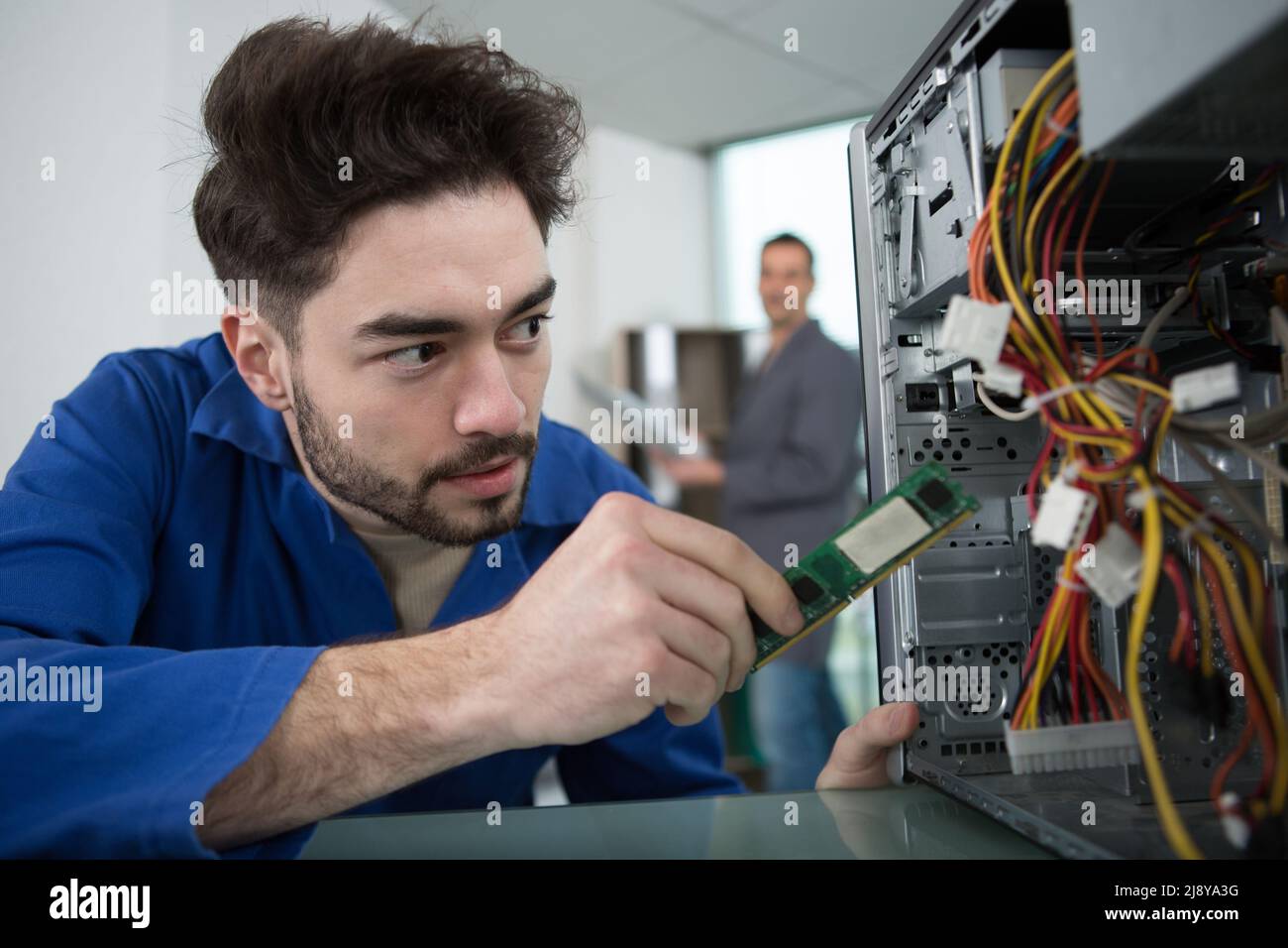 concentrated electrician checks pc cables Stock Photo - Alamy