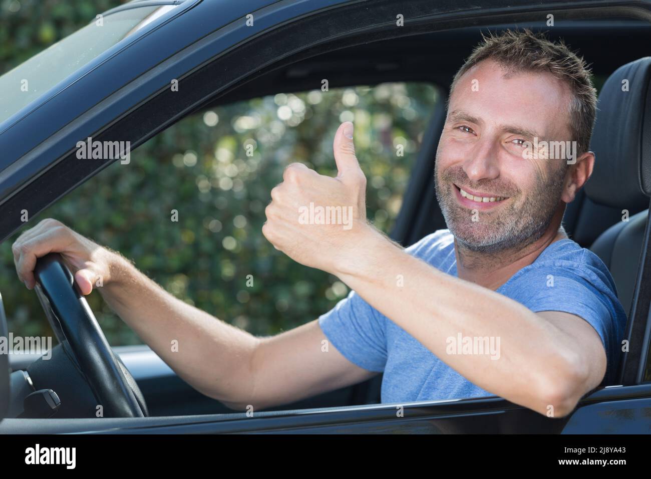 man in a car giving thumbs up Stock Photo - Alamy