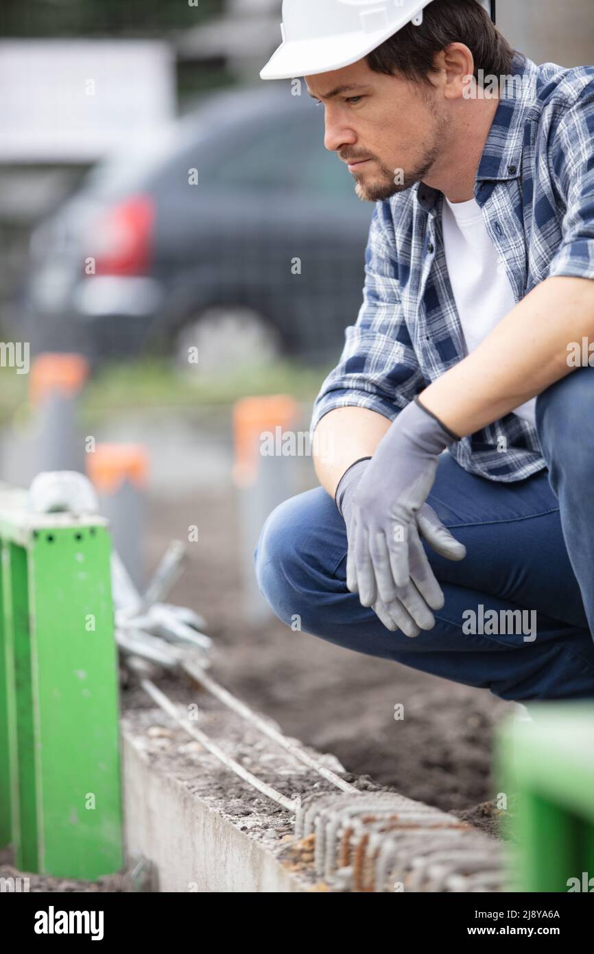 young builder laying foundation base Stock Photo - Alamy