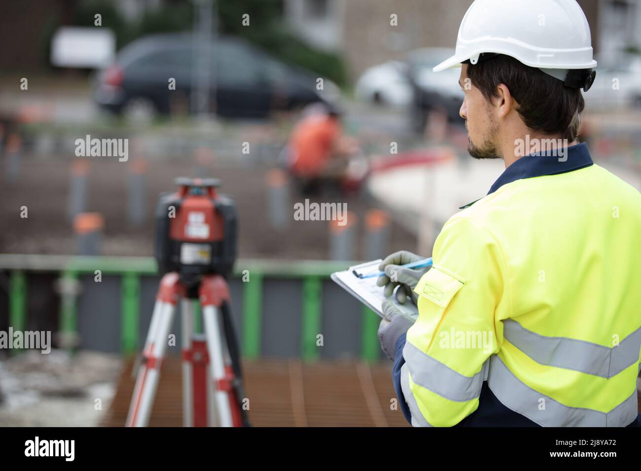 geometer measuring foundation at construction site Stock Photo - Alamy