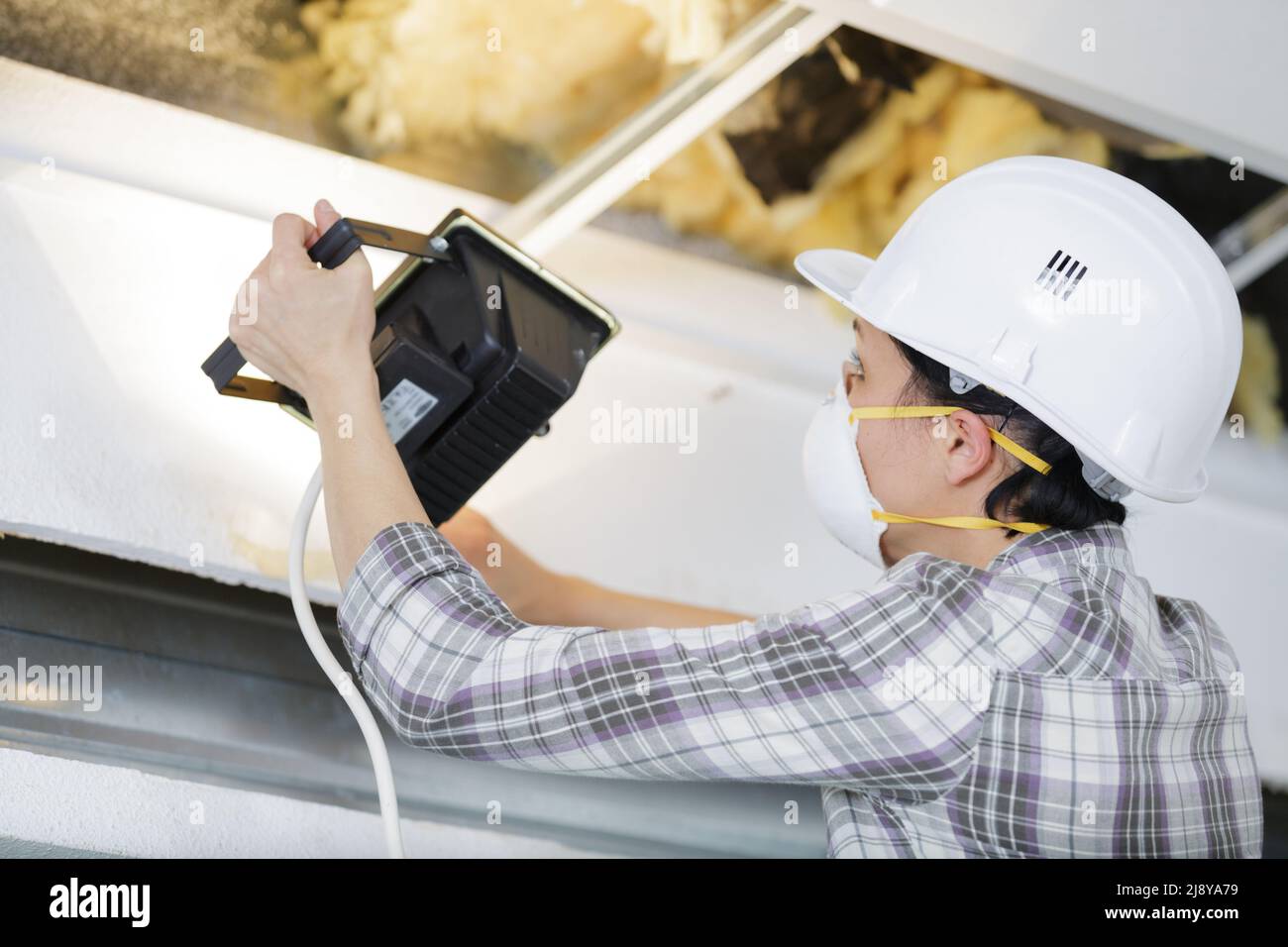 woman builder fixing a problem in the ceiling Stock Photo - Alamy