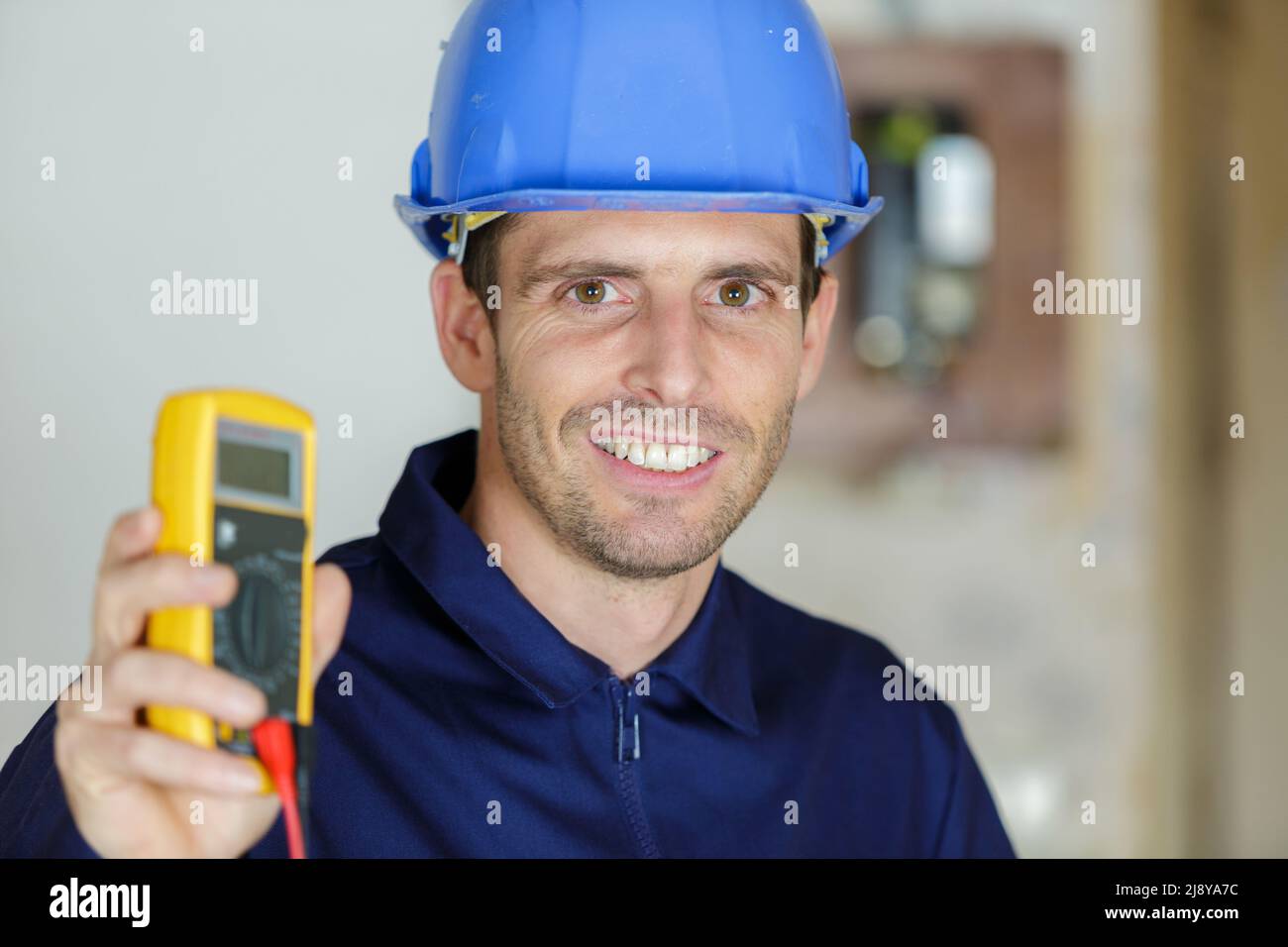 electrician showing machine to measure electrical current Stock Photo ...