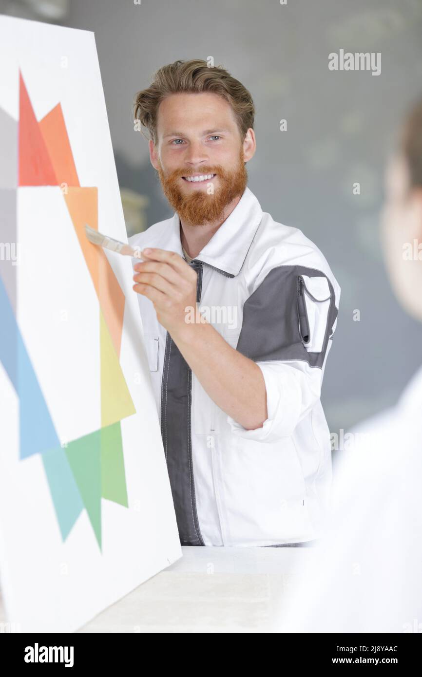 Handsome young smiling painter hi-res stock photography and images - Alamy