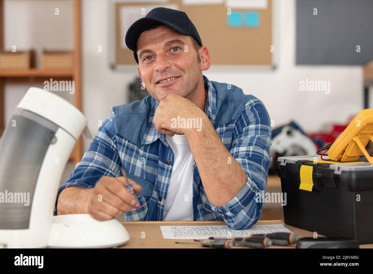 happy man repairing broken coffee machine Stock Photo - Alamy
