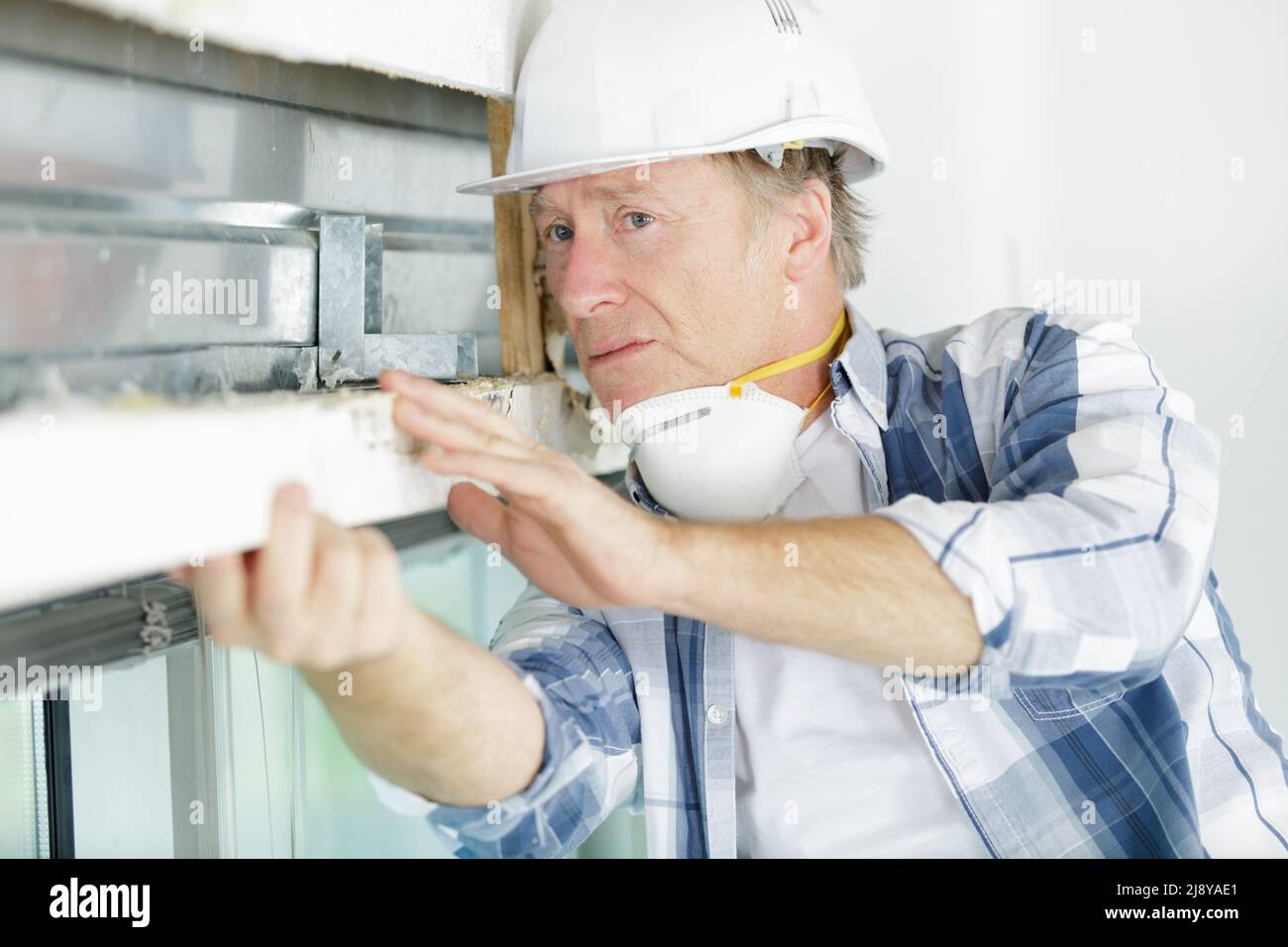 construction worker inspecting new window in house Stock Photo - Alamy