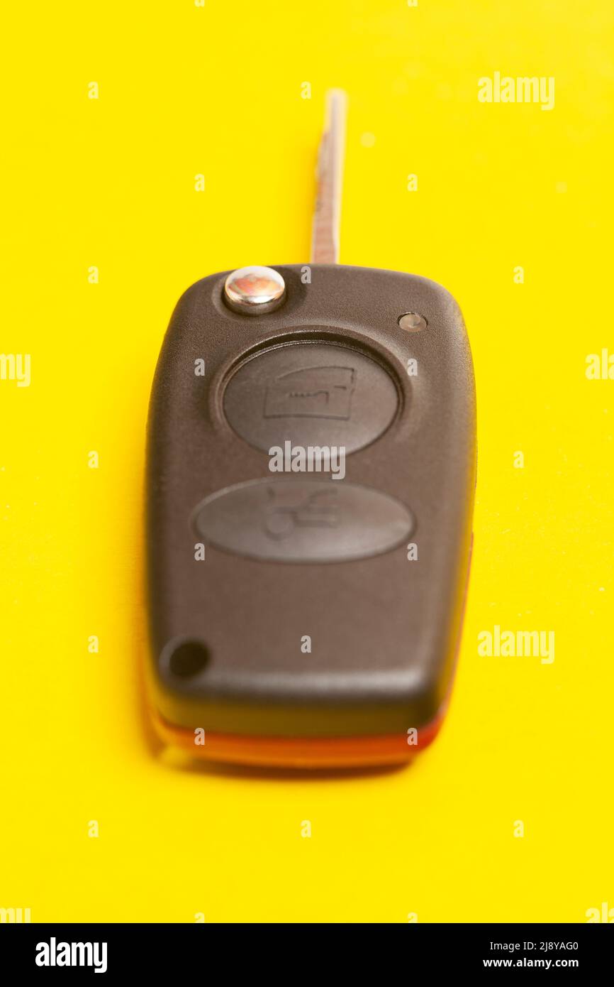 New car key on yellow background Stock Photo - Alamy