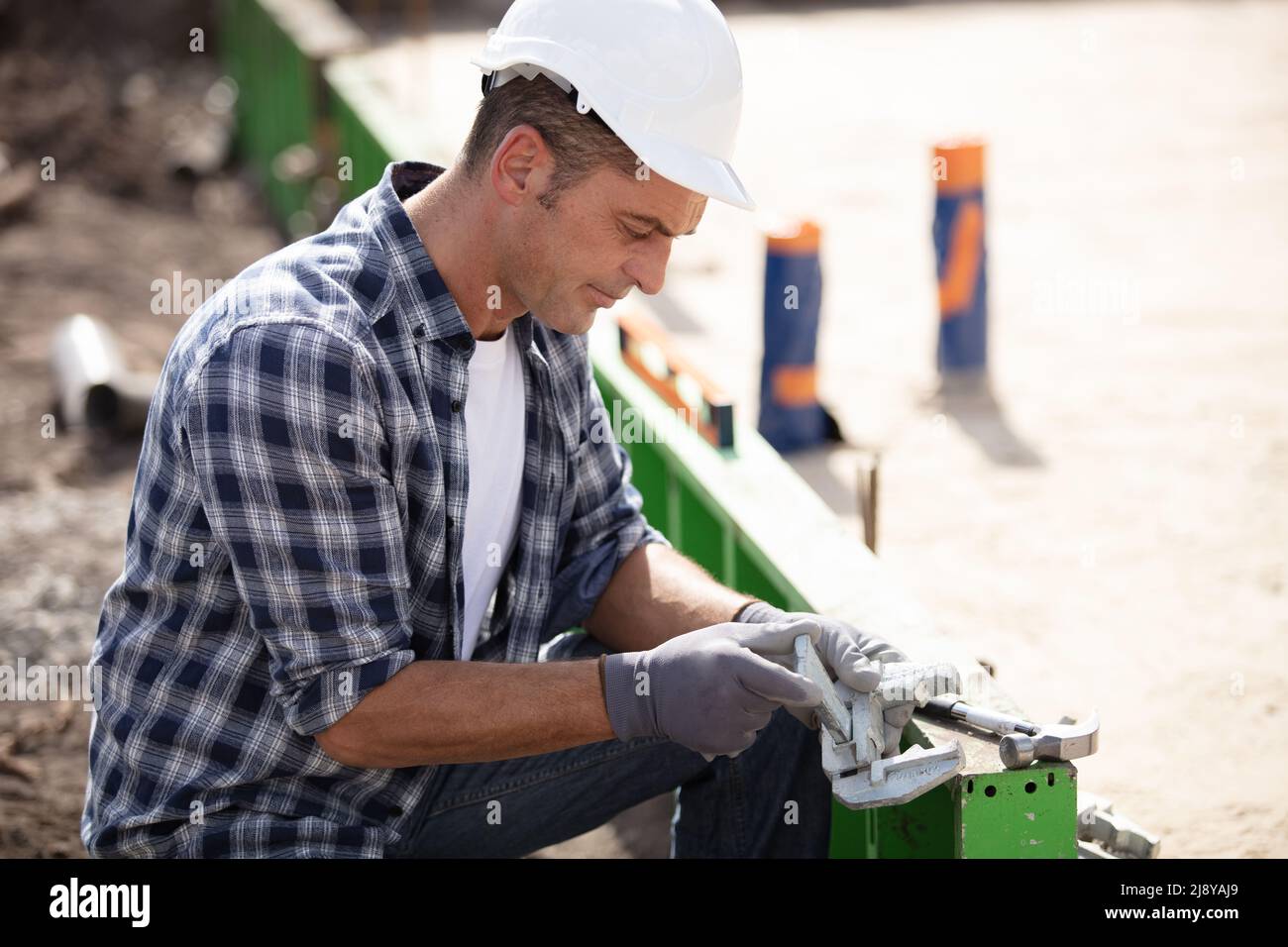 construction worker laying foundations at building site Stock Photo - Alamy