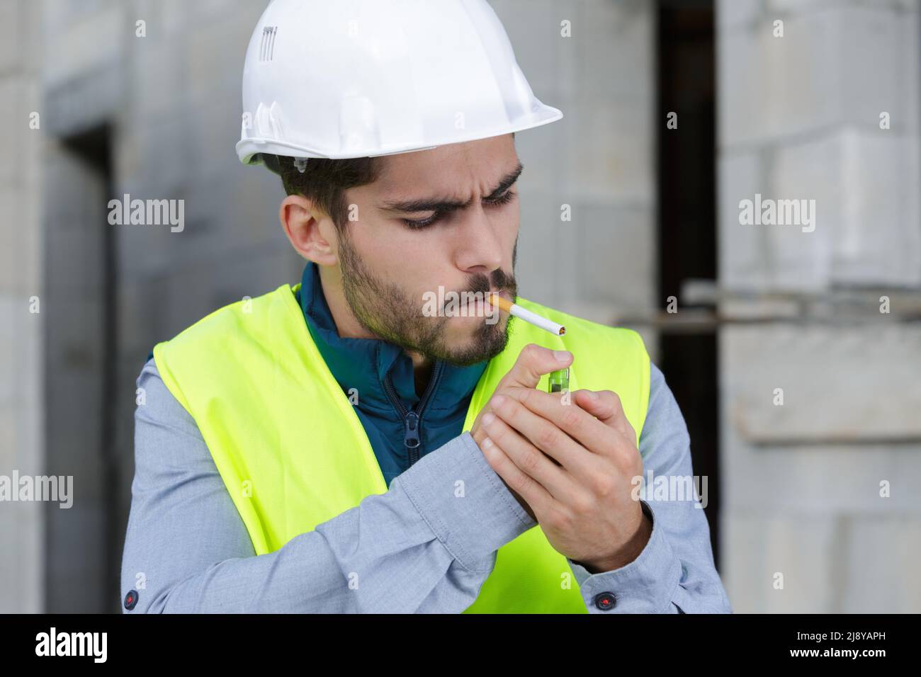smoking cigarette on construction site Stock Photo - Alamy