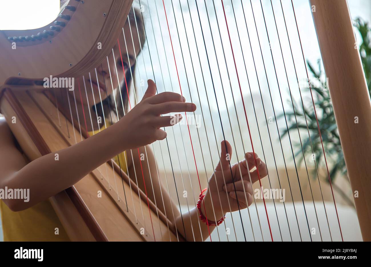 The child plays the harp. Selective focus Stock Photo - Alamy