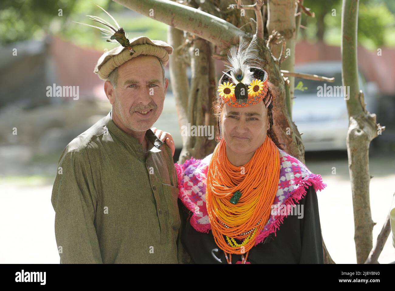 Kalashi women and men wearing traditional dresses participating in the ...