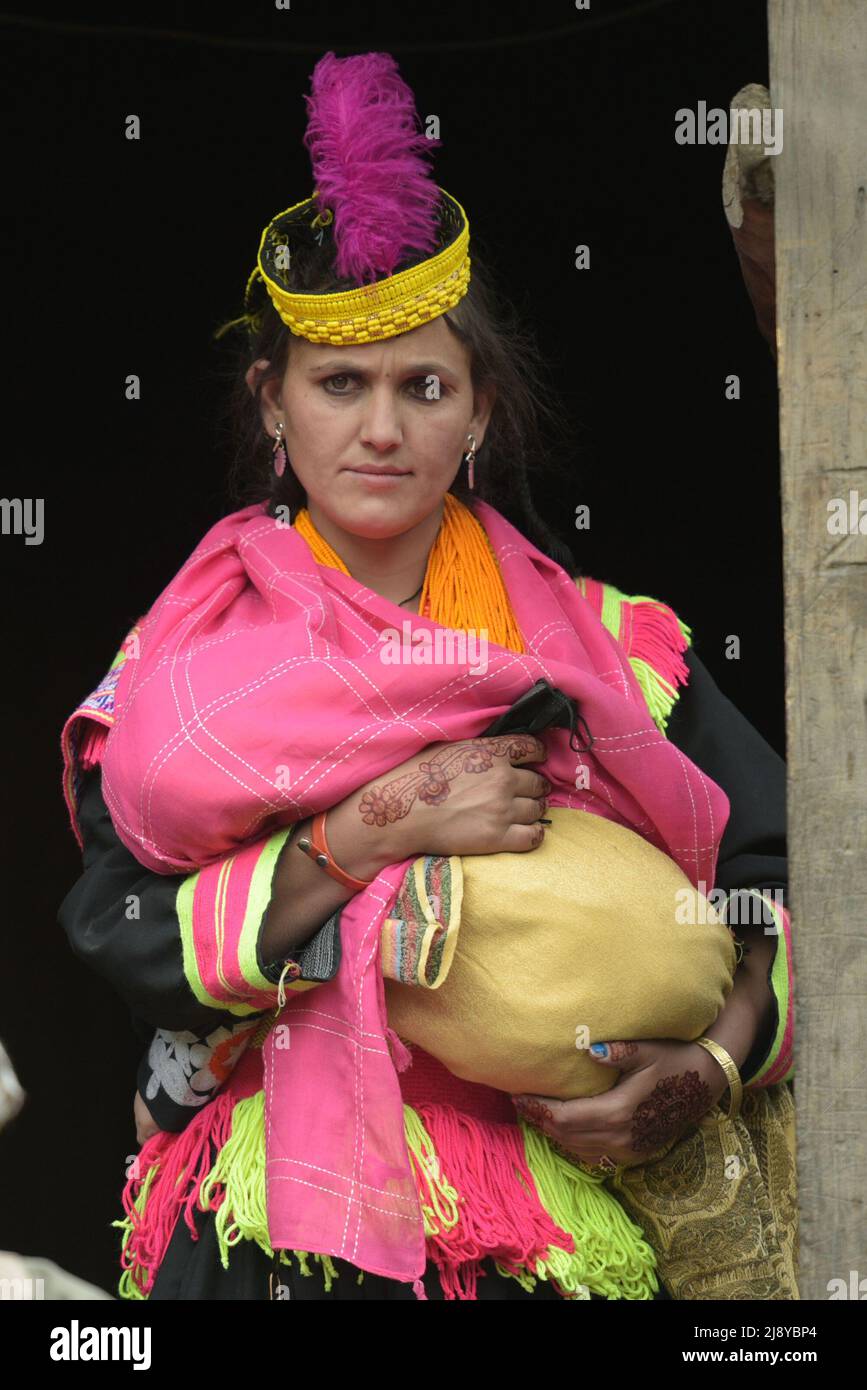 Kalashi women and men wearing traditional dresses participating in the ...
