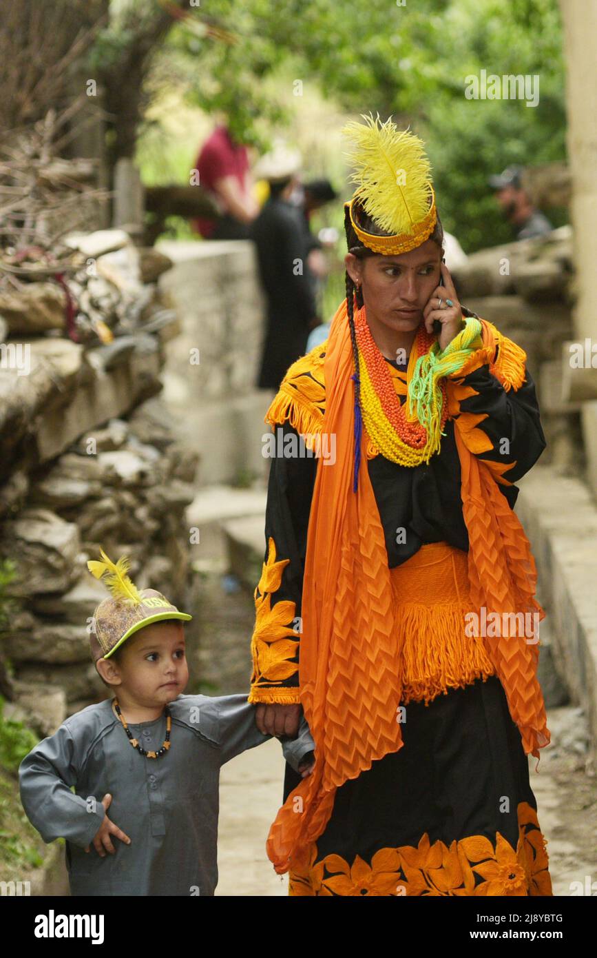 Kalashi women and men wearing traditional dresses participating in the ...