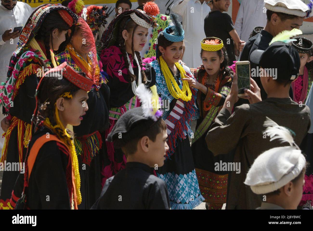 Kalashi women and men wearing traditional dresses participating in the ...