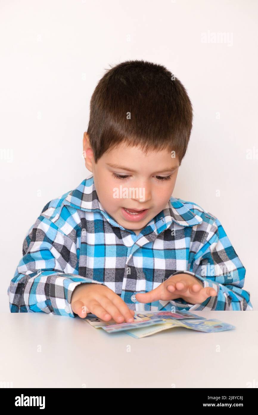 Money in the hands of a child hi-res stock photography and images - Alamy