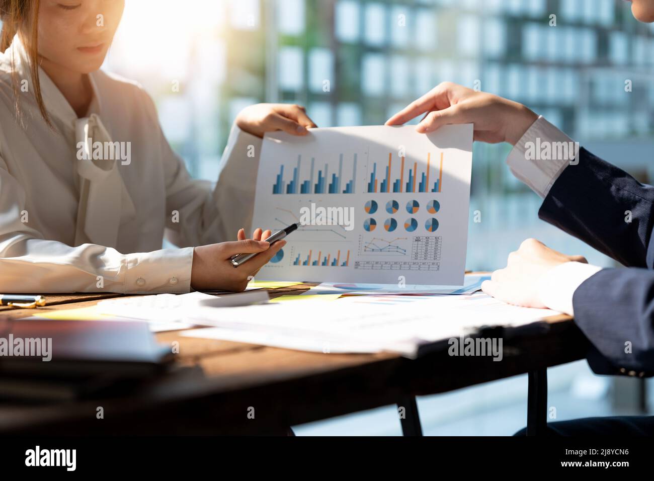 Financial, accounting, investment advisor consulting with her team at ...