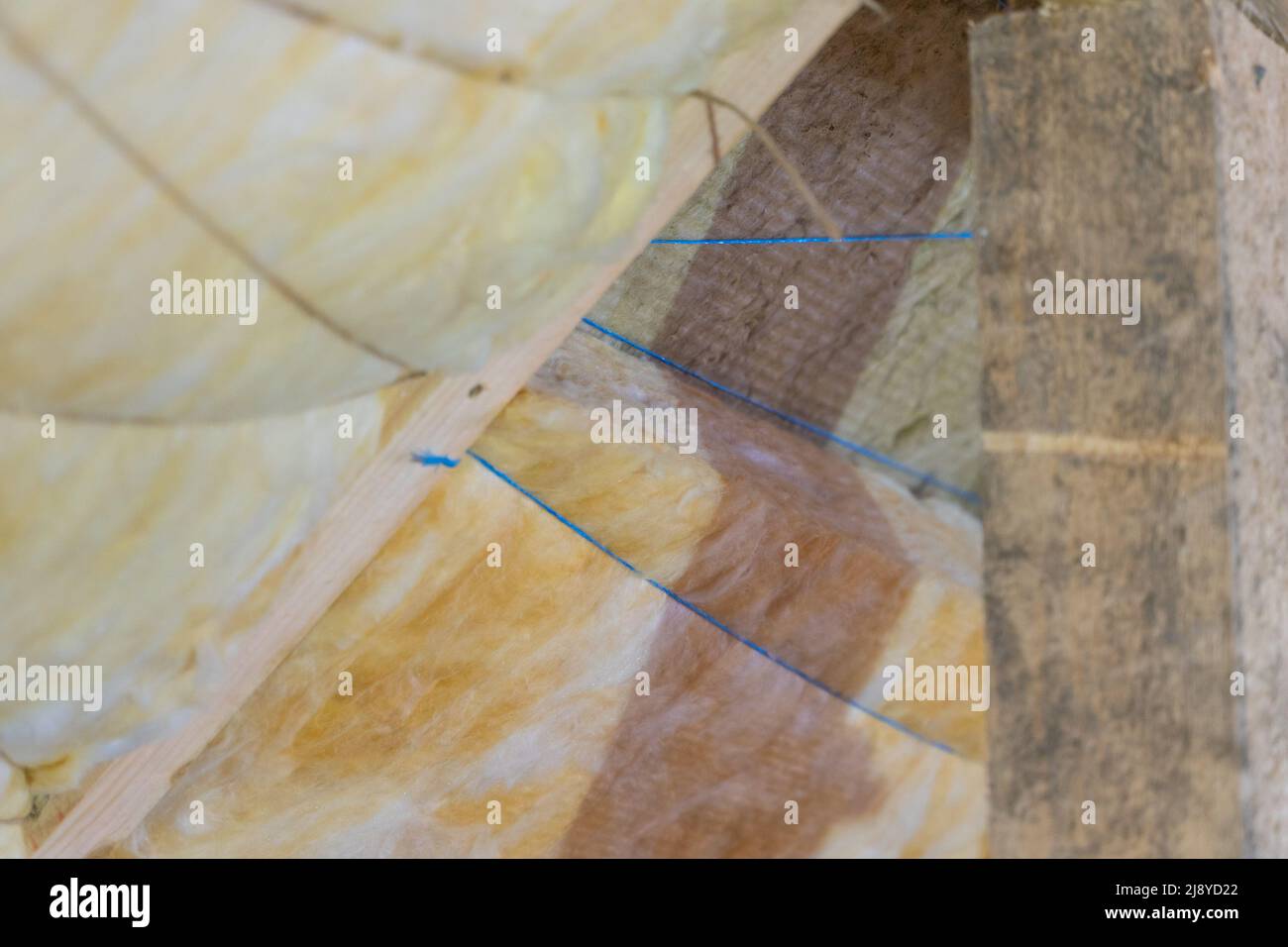 Roof insulation in two layers of mineral wool and glass wool overlap ...