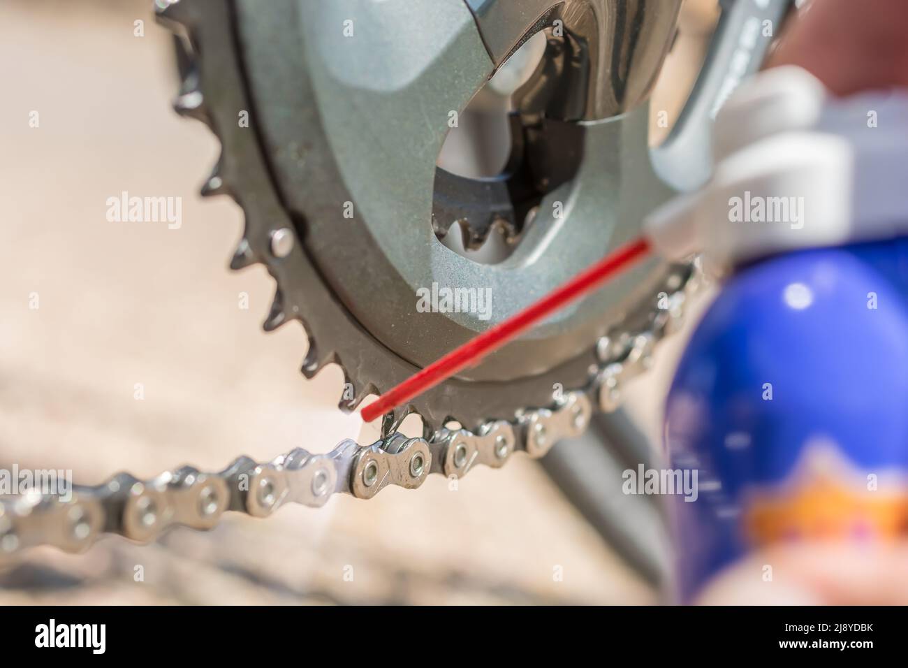 Care of the bicycle chain through regular cleaning and oiling Stock ...