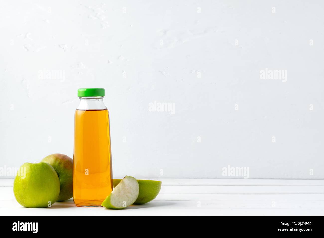 Glass bottle of apple juice with apple fruit on white background Stock ...