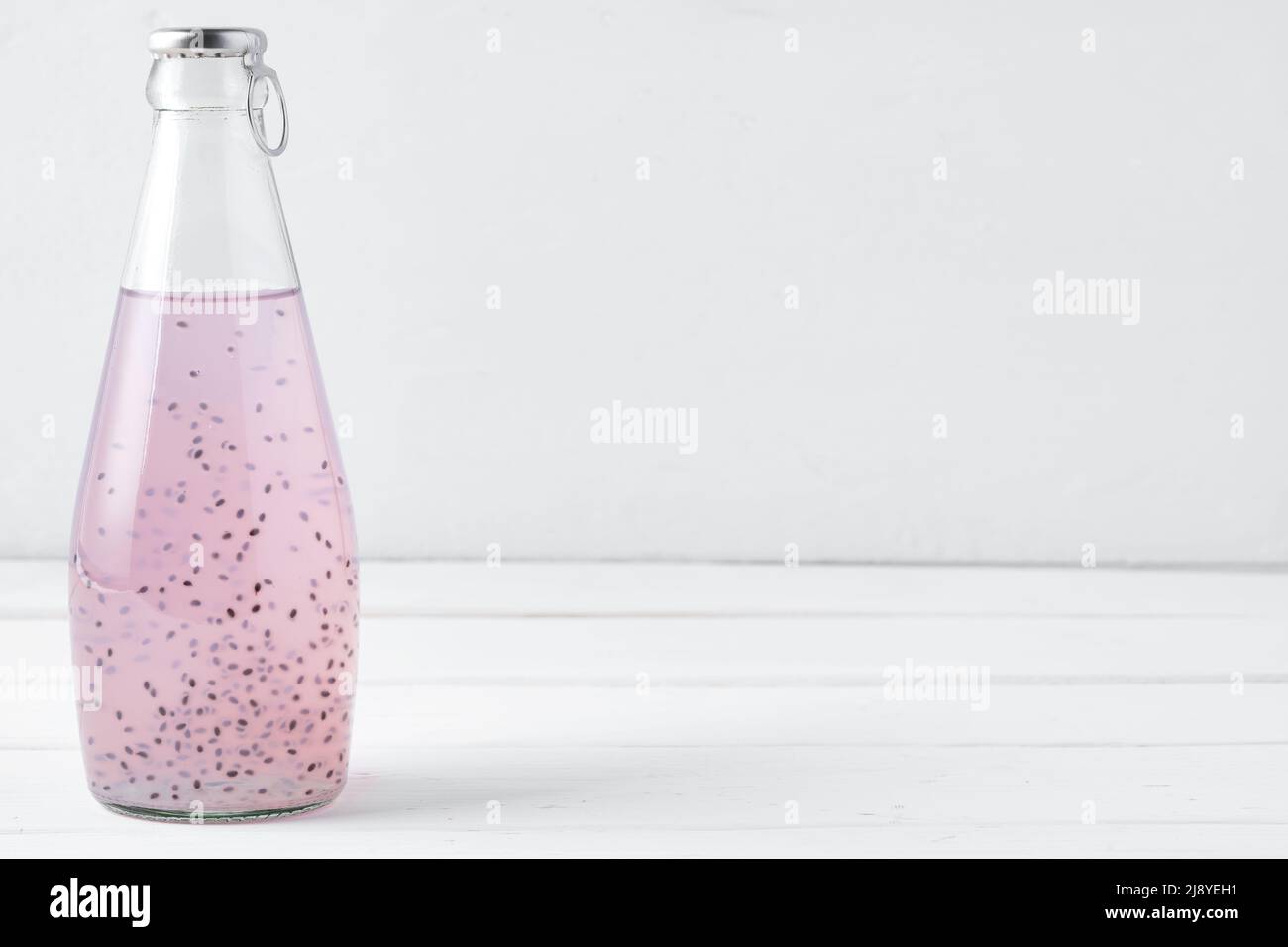 Basil seed drink in glass bottle on white background Stock Photo - Alamy