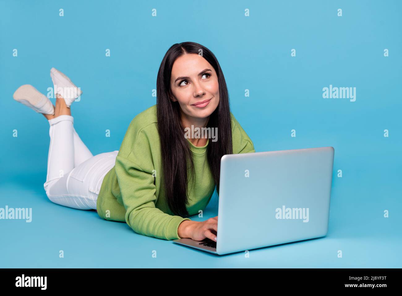 Full size photo of minded gorgeous lady lay floor look interested empty ...