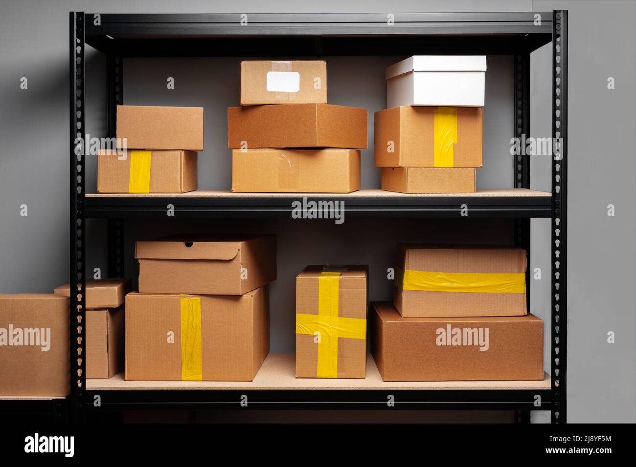 Rows of shelves with cardboard boxes in modern warehouse Stock Photo ...
