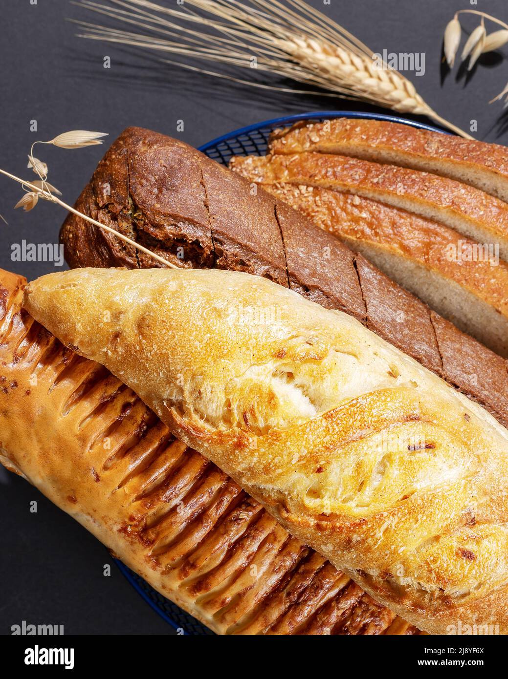 Different kind of natural breads. Fresh loafs of bread in the blue ...