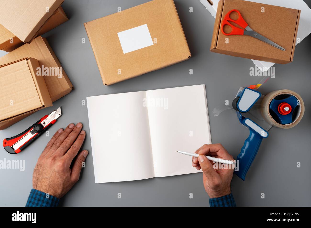 Above table top view of warehouse preparing post courier delivery ...