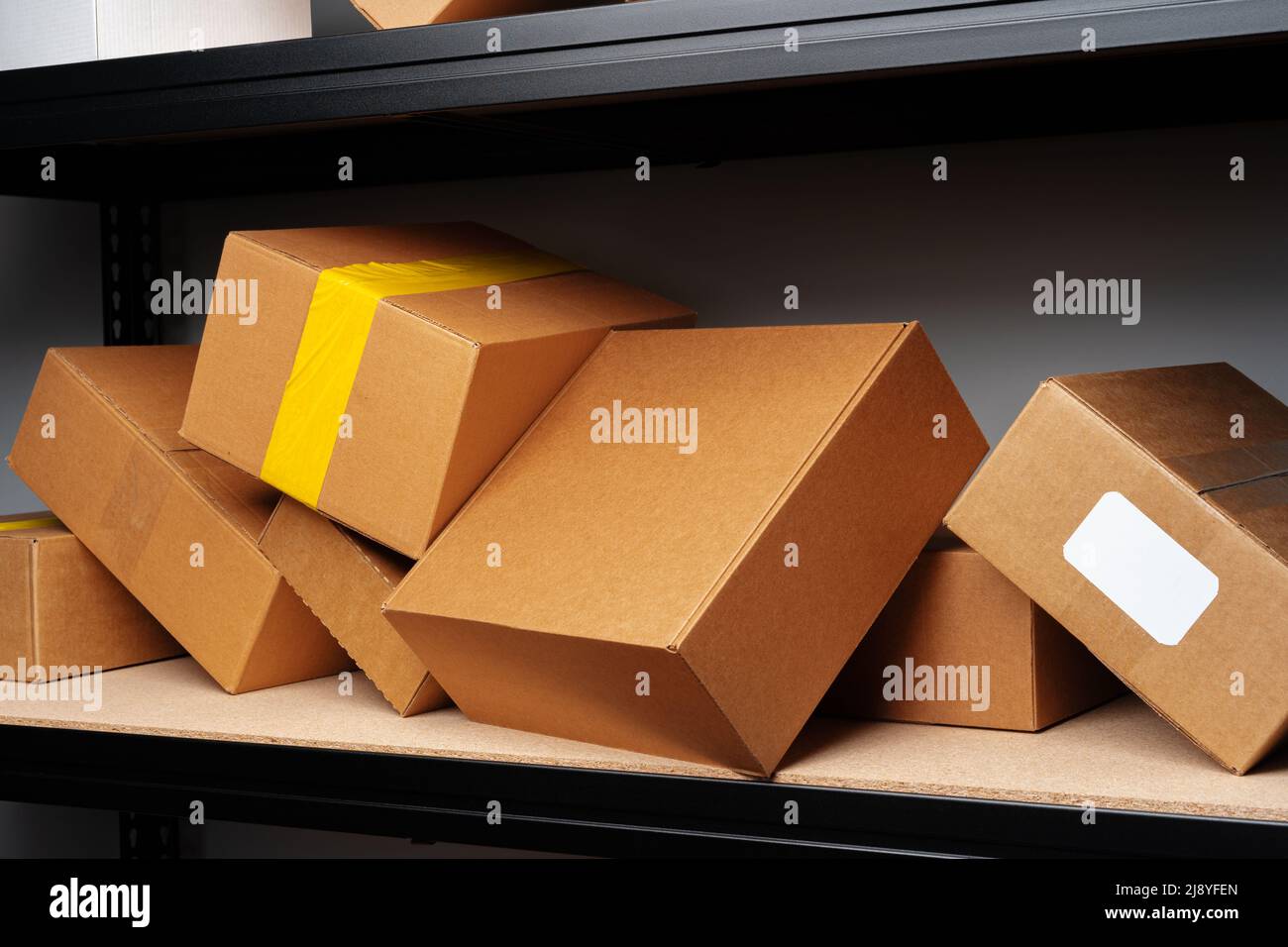 Rows of shelves with cardboard boxes in modern warehouse Stock Photo ...