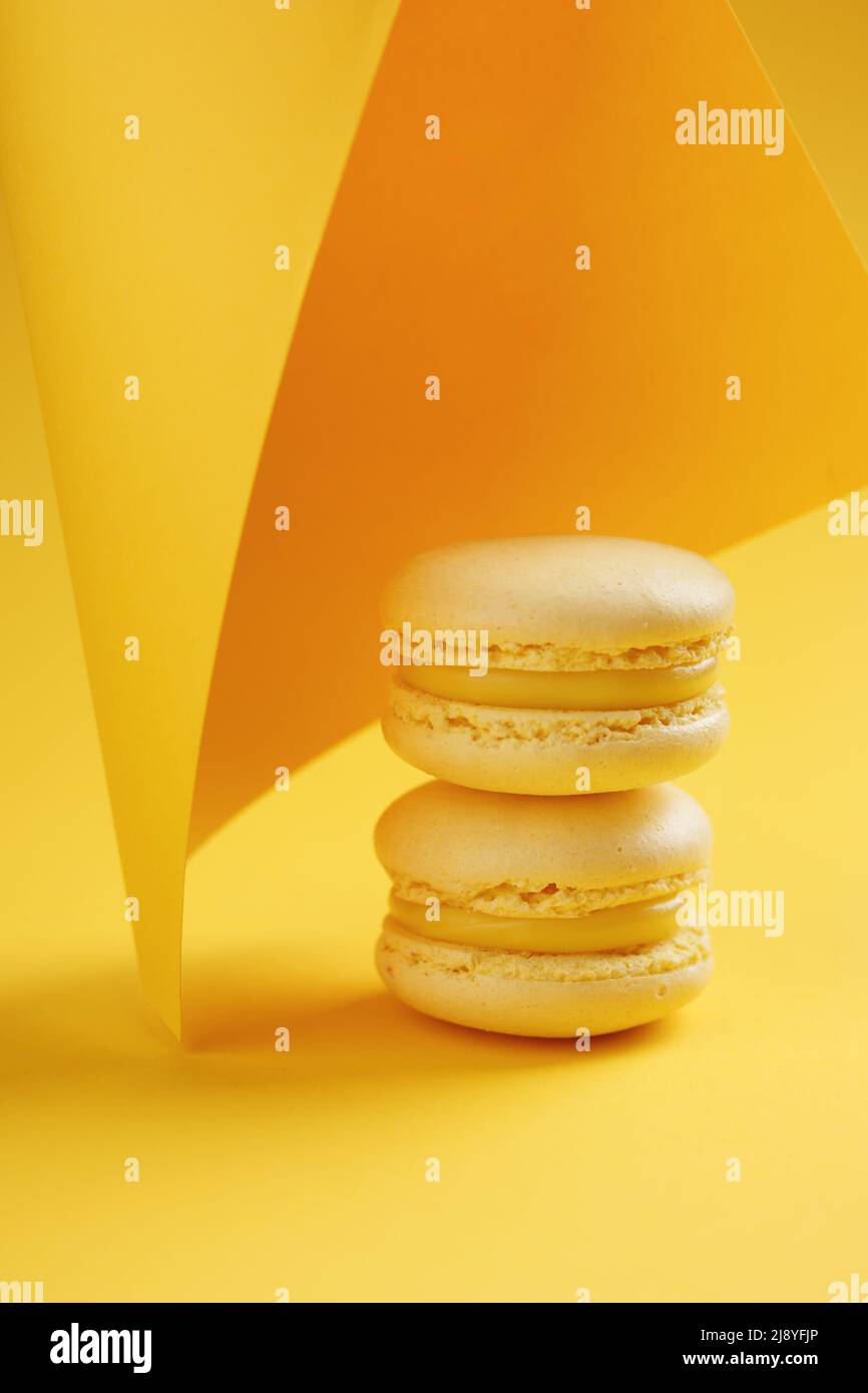 Lemon macaroons on a yellow background vertical Stock Photo - Alamy