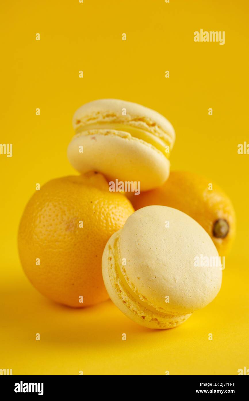 Lemon macaroons on a yellow background vertical Stock Photo - Alamy