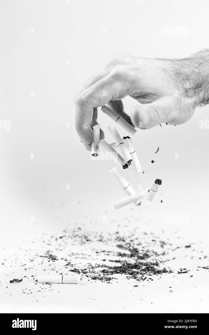 The concept of nicotine addiction and anti-Smoking. A man's hand throws ...