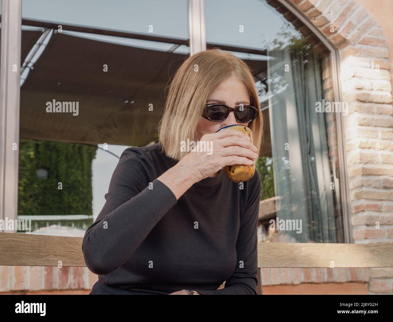 elegant fit lady having espresso coffee outdoors a sunny day Stock ...