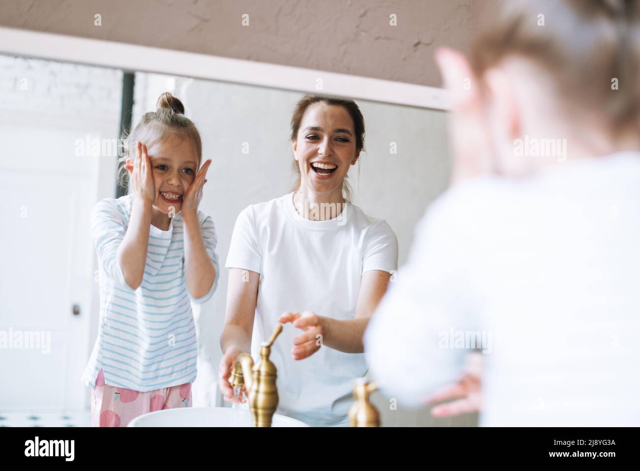 Young mother woman with long hair with little tween girl daughter in ...