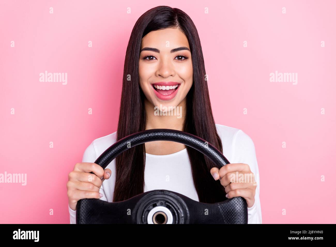 Photo of impressed millennial brunette lady drive car wear white shirt ...