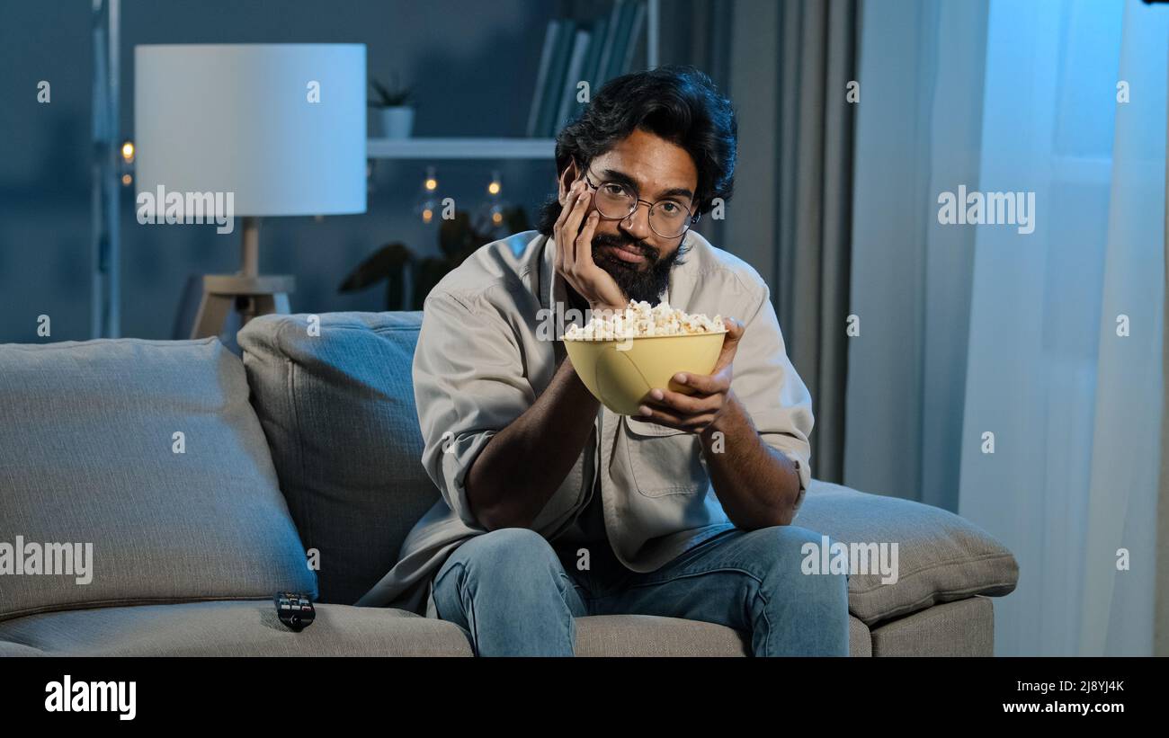 Upset sad bored Arab man tired indian male with beard sits at home ...