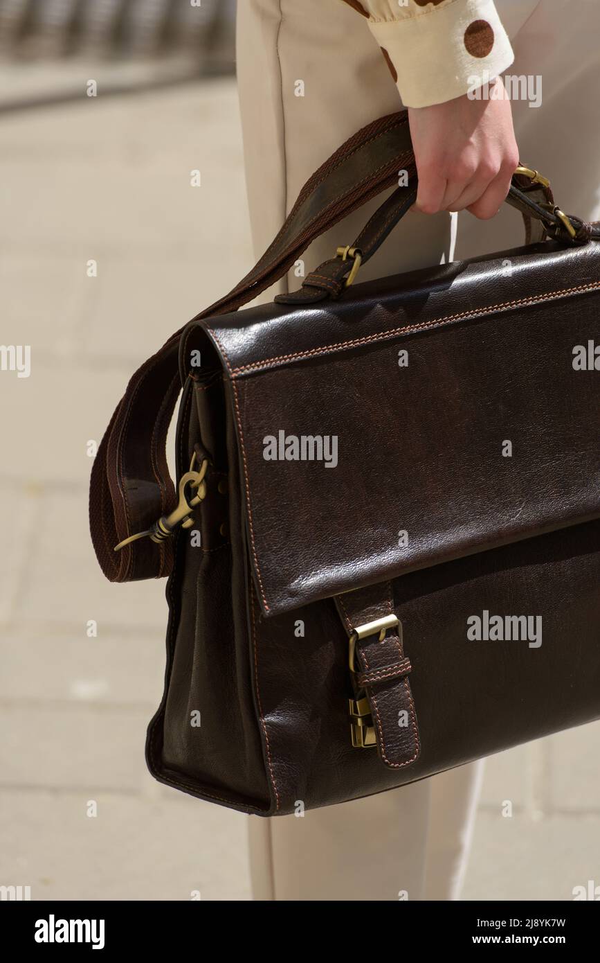 Part photo of a woman with a brown leather briefcase with antique and ...