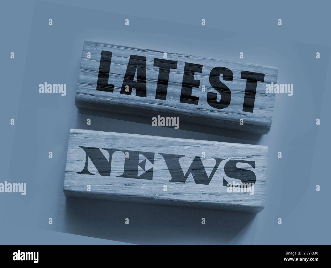 Latest News words on a wooden blocks on yellow and magenta background ...