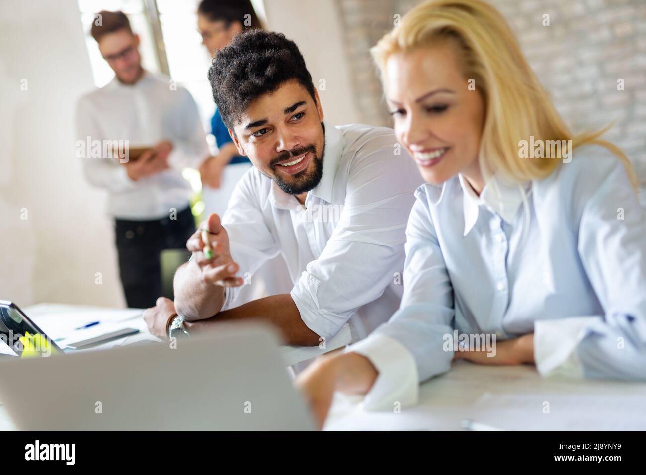 Group of happy multiethnic business people cooperating, working on ...