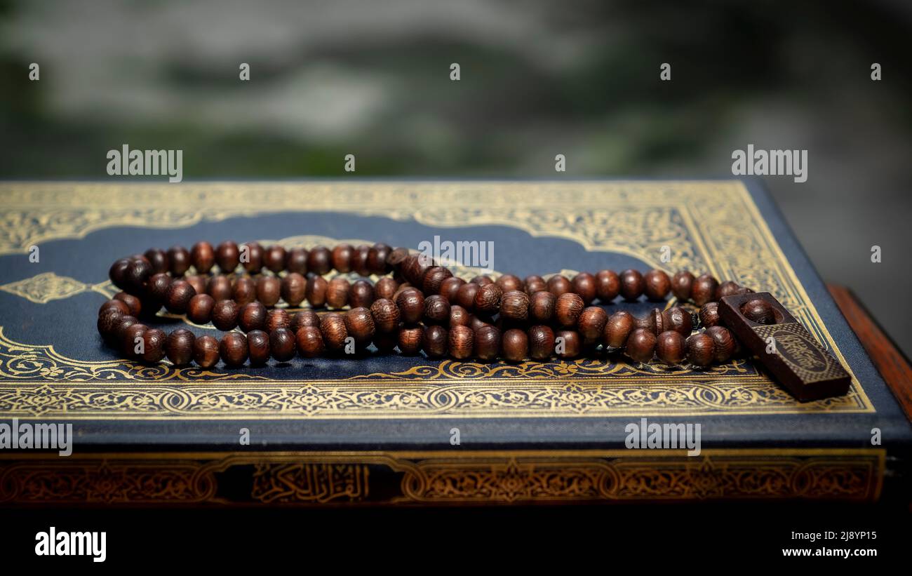 Background wallpaper of rosary beads (tasbih) and The holy coran Quran ...