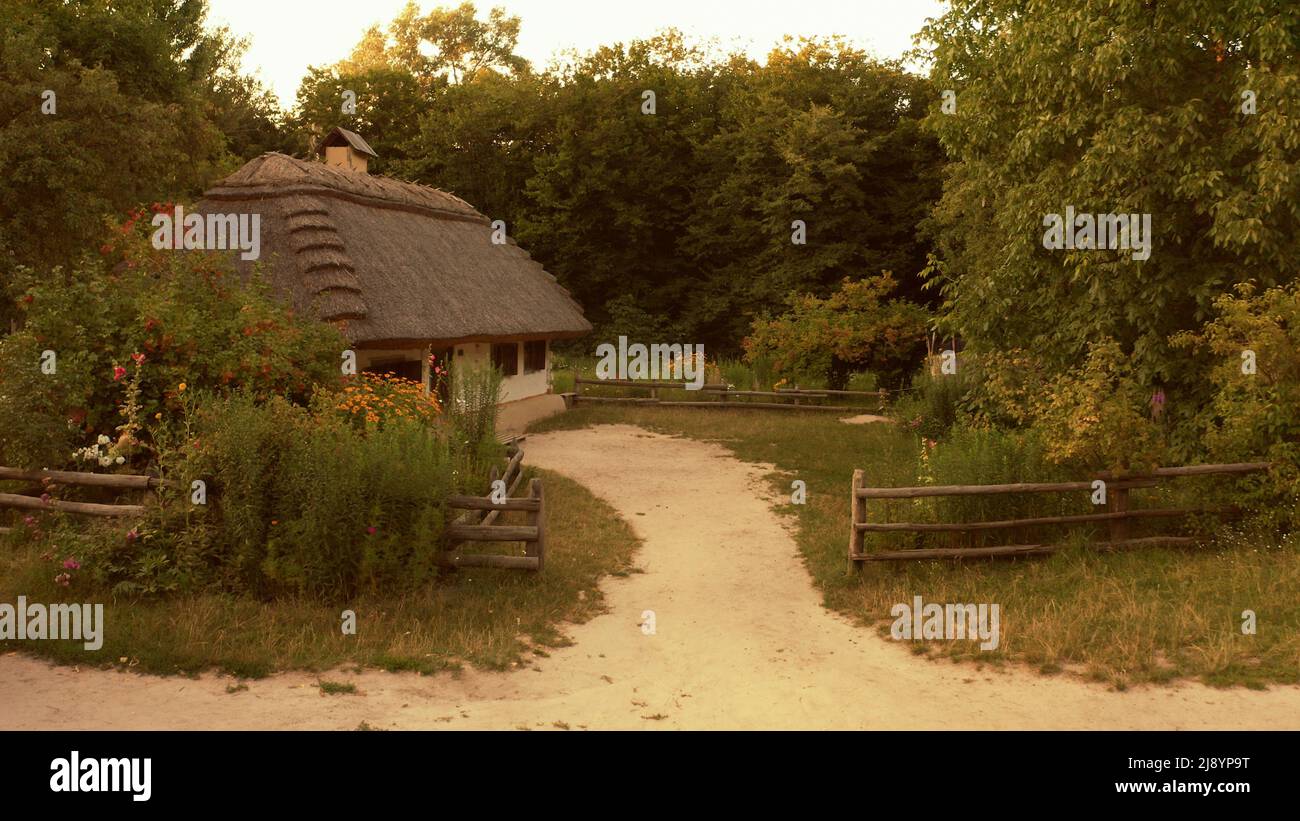 Path leading to the old house fenced by a wooden fence. House is in the ...