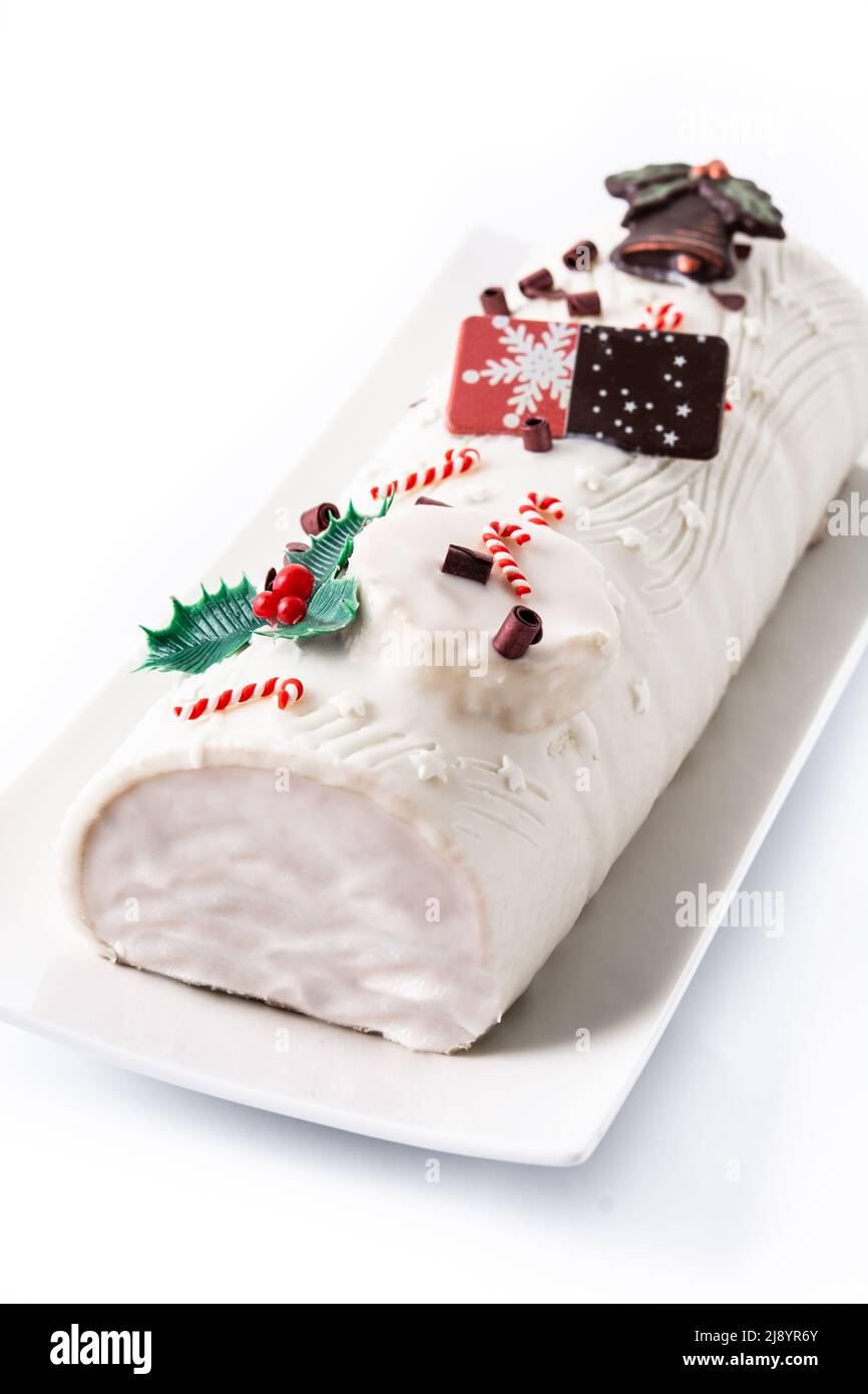 White chocolate yule log cake with ornament isolated on white ...
