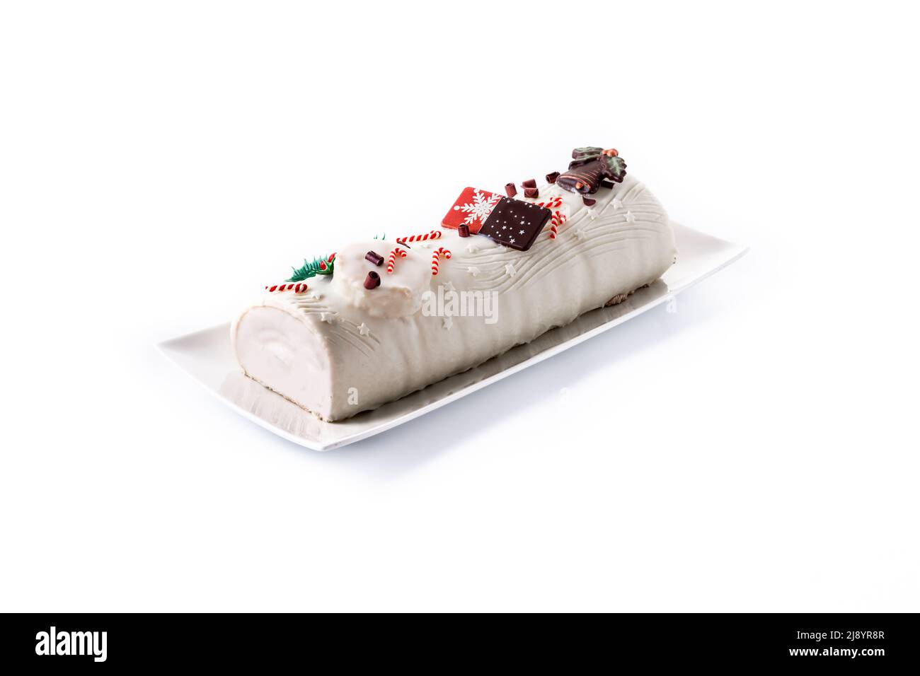 White chocolate yule log cake with ornament isolated on white ...