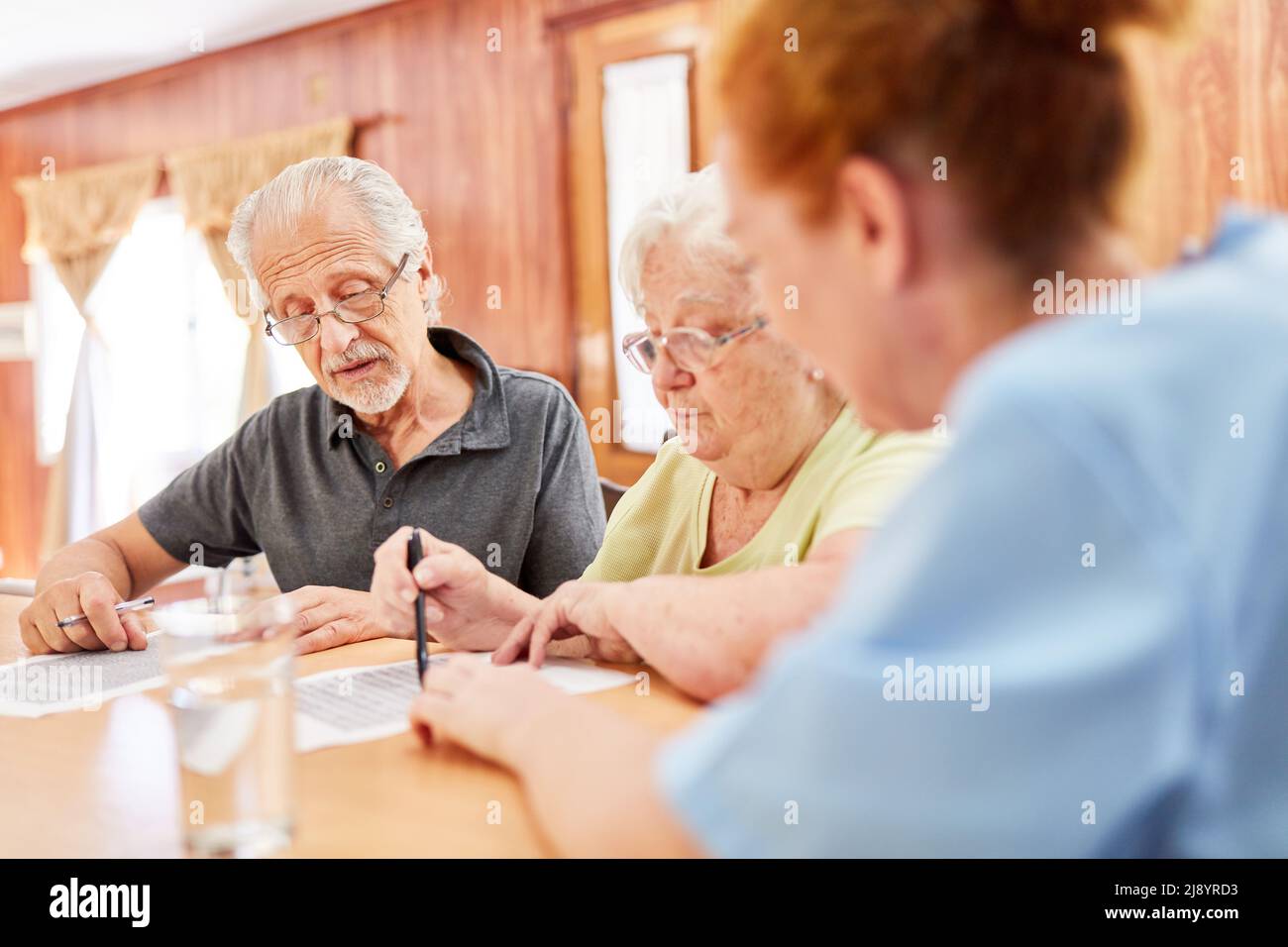 Seniors with dementia solving puzzles as memory training supervised by ...