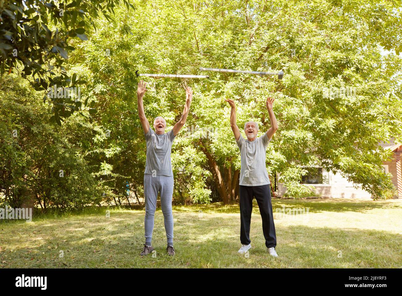 Seniors throwing their canes in the air as a concept for fun and joie ...