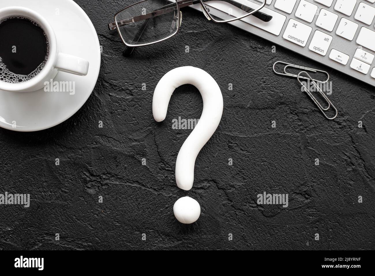 Question mark signs on office table. Customer support servise or FAQ ...