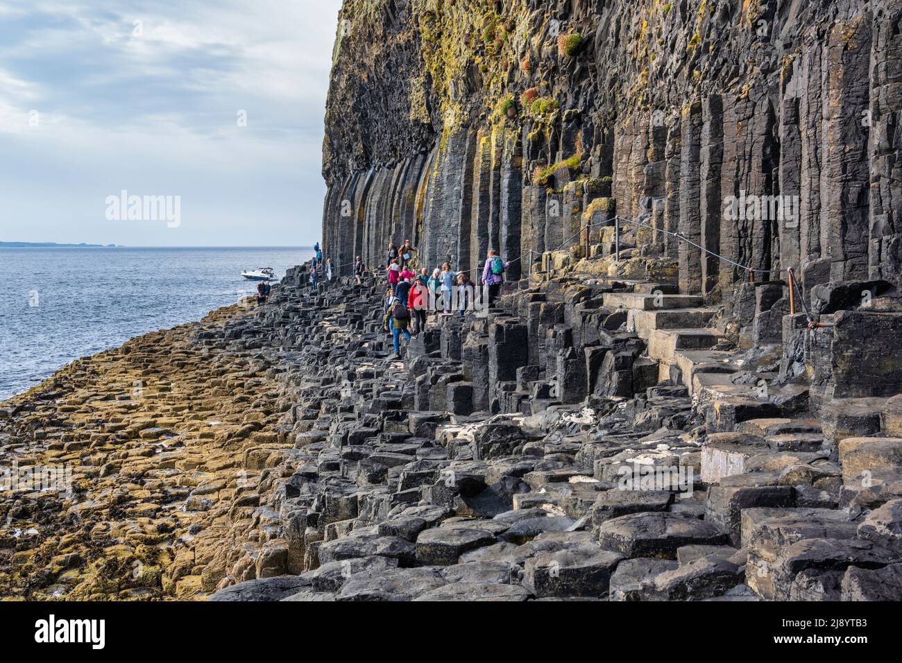 A rough handrail guides sightseers along the precarious route to Fingal ...