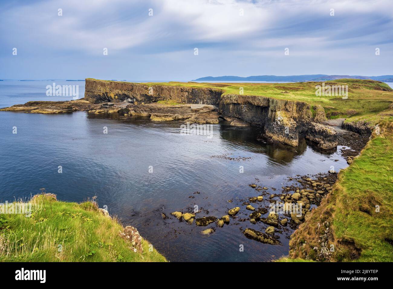 Dramatic Sea cliffs and grassy headland on west coast of Isle of Staffa ...