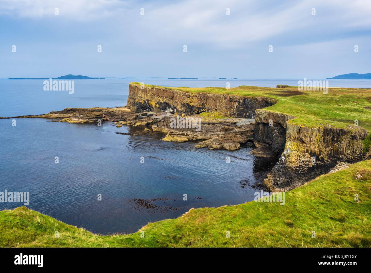 Dramatic Sea cliffs and grassy headland on west coast of Isle of Staffa ...