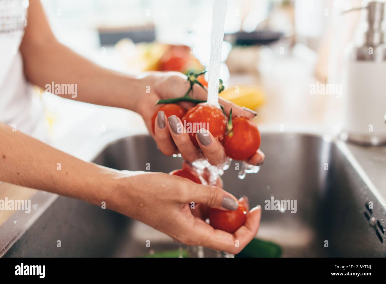 Woman tomato vine kitchen hi-res stock photography and images - Alamy
