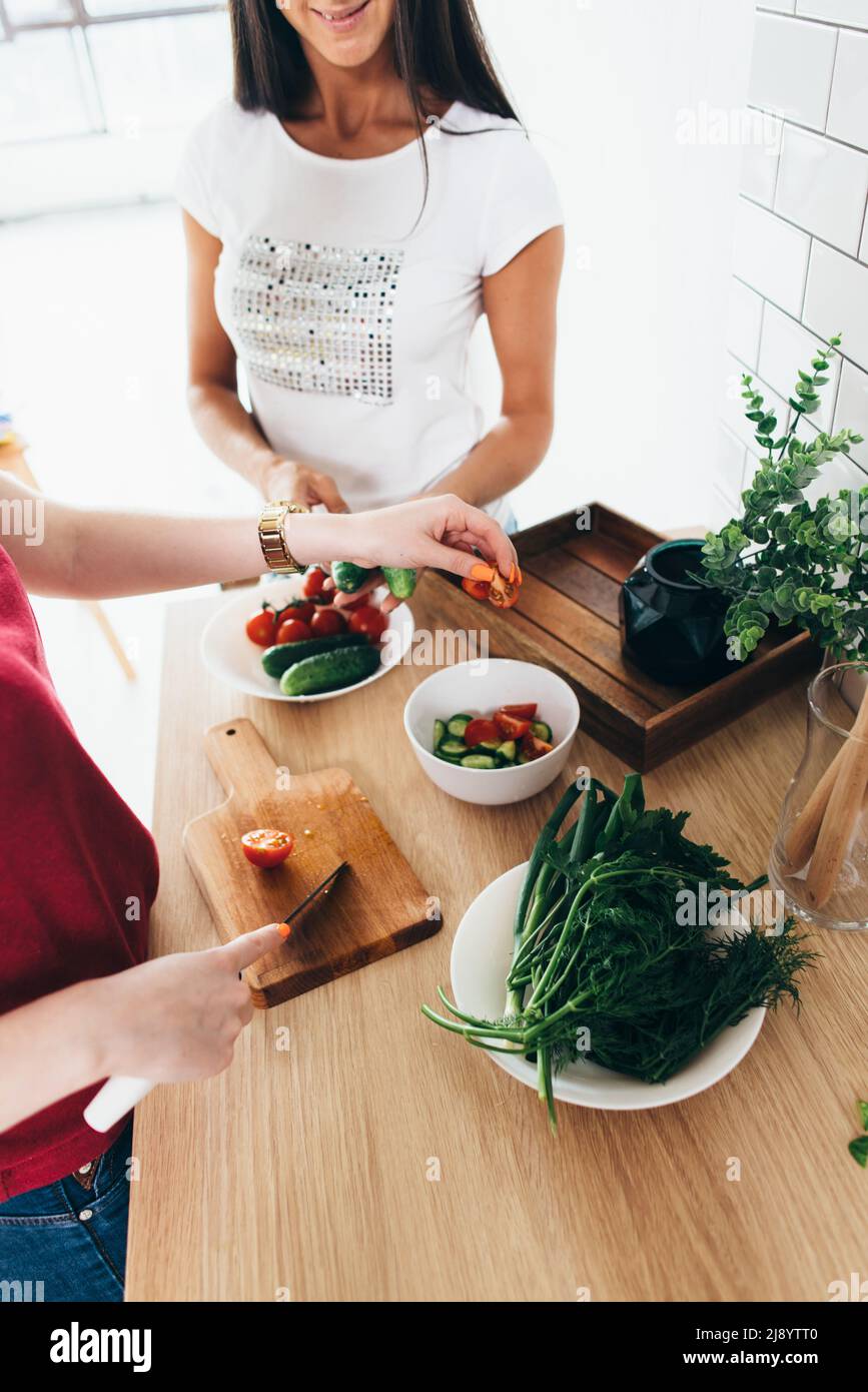 Two girls in kitchen slicing hi-res stock photography and images - Alamy